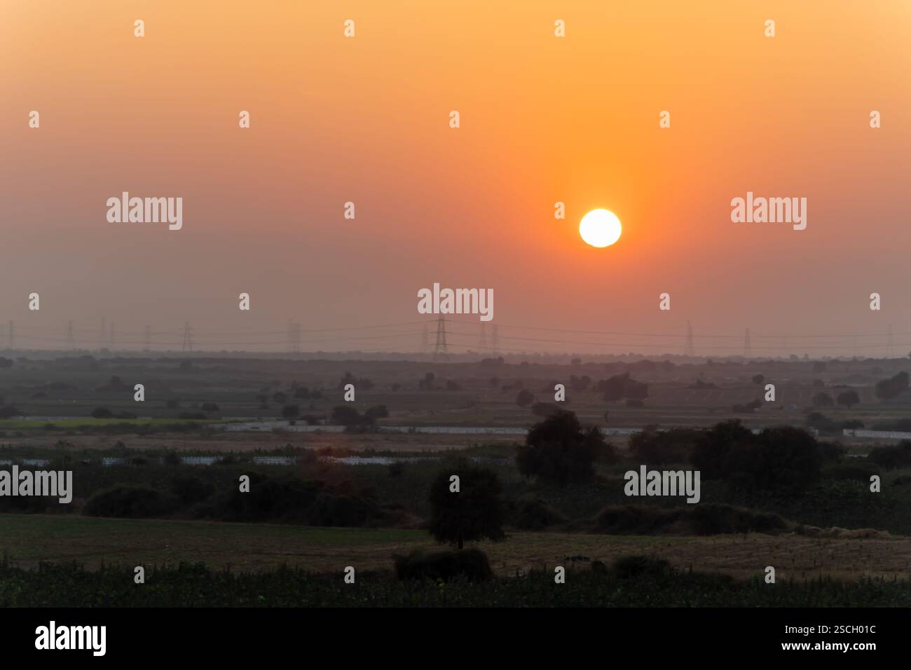 sunset view over hazy city with orange sky at dusk Stock Photo - Alamy