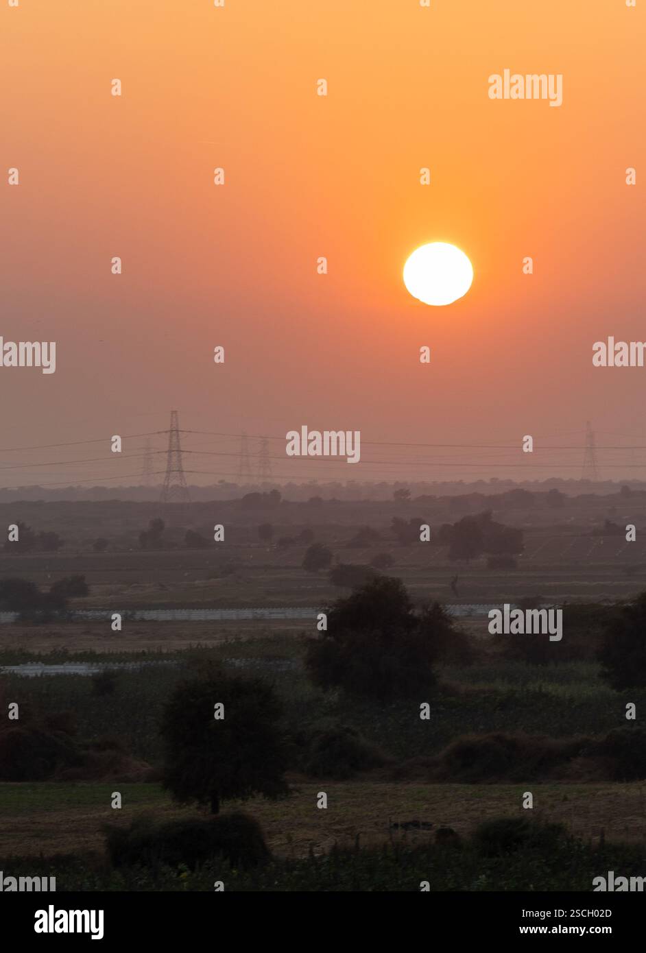 sunset view over hazy city with orange sky at dusk Stock Photo - Alamy