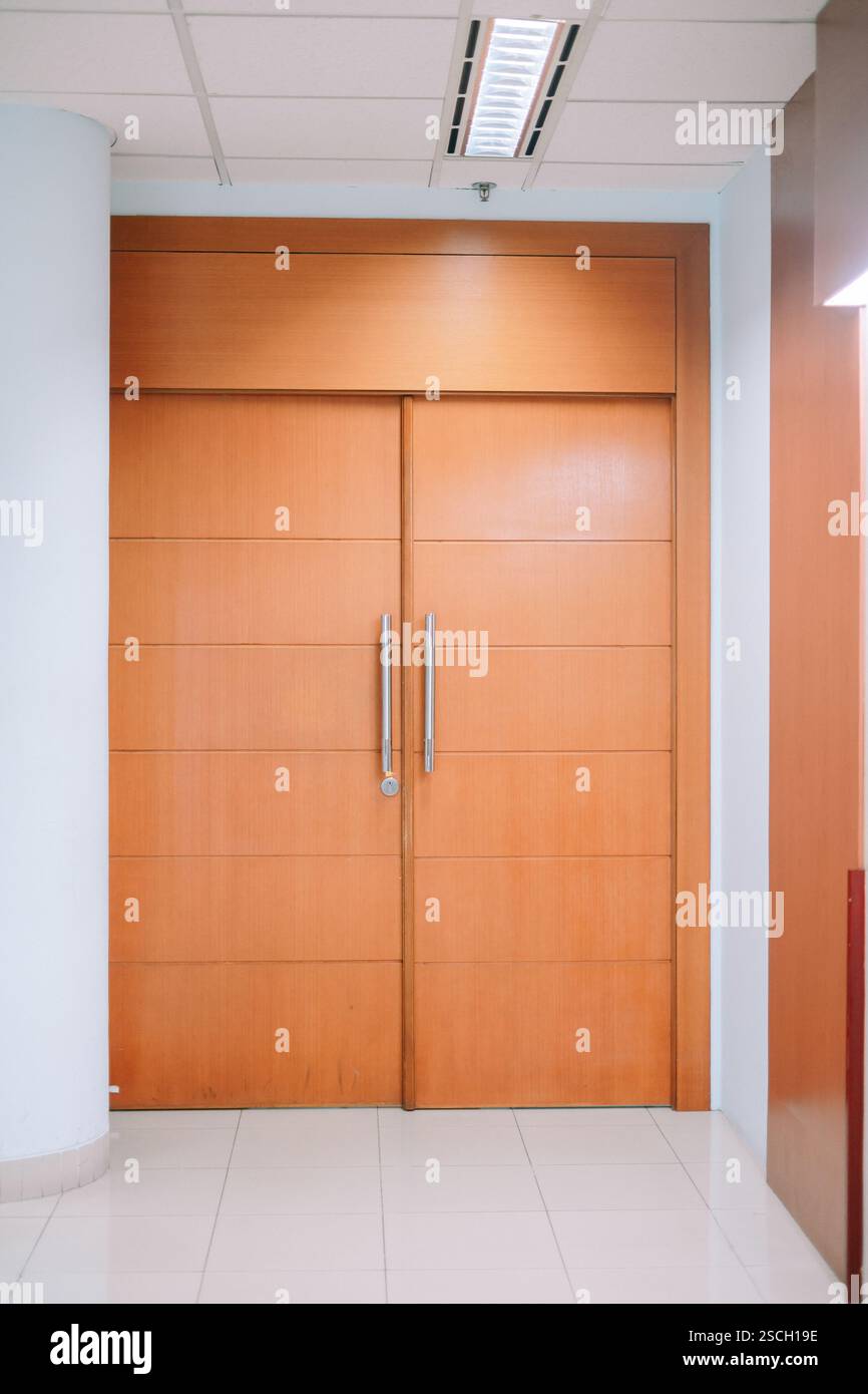 Simple and elegant closed wooden double doors in a hallway Stock Photo ...