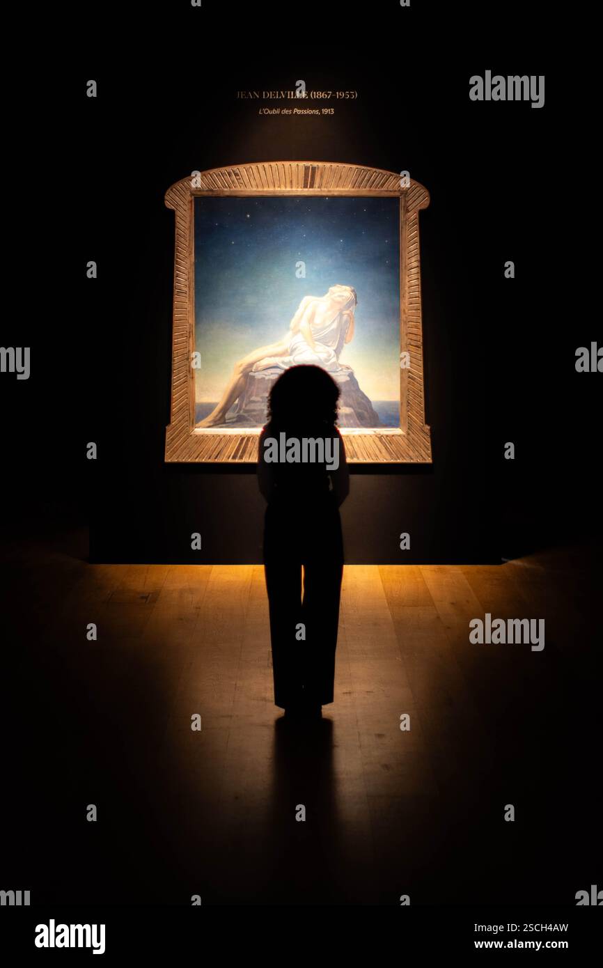 A member of staff looks at L'oubli des Passions, by Jean Delville ...