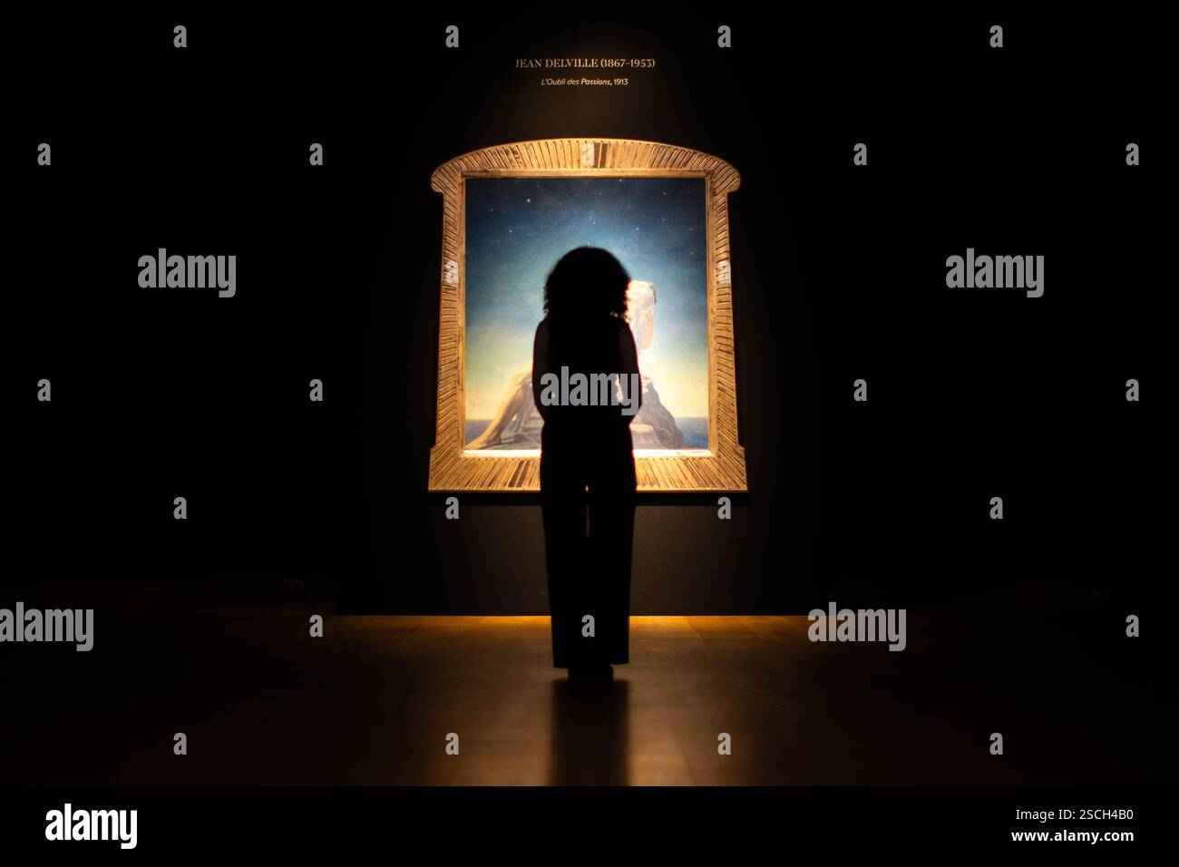 A member of staff looks at L'oubli des Passions, by Jean Delville ...