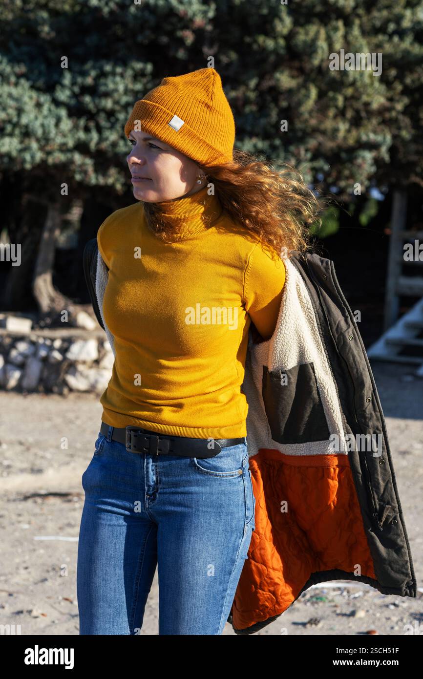 Woman taking off jacket hi-res stock photography and images - Alamy