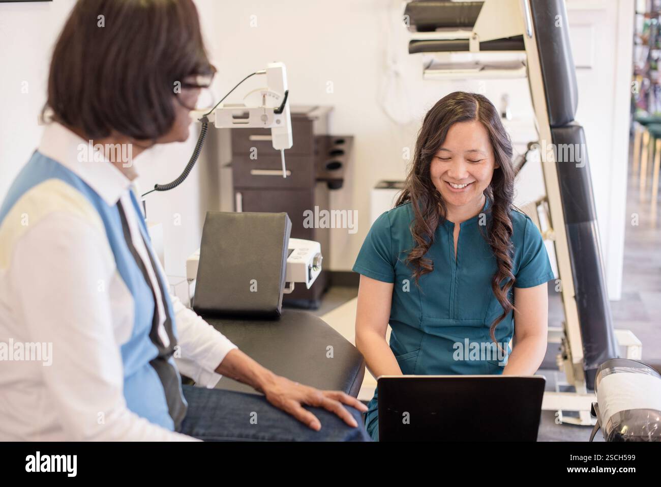 Doctor taking note from patient Stock Photo - Alamy