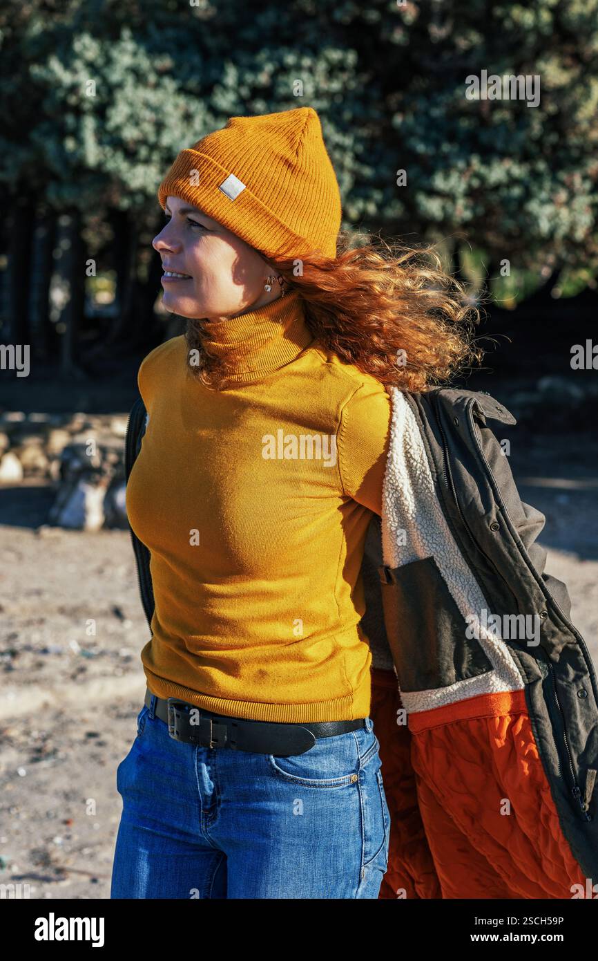 Woman taking off jacket hi-res stock photography and images - Alamy