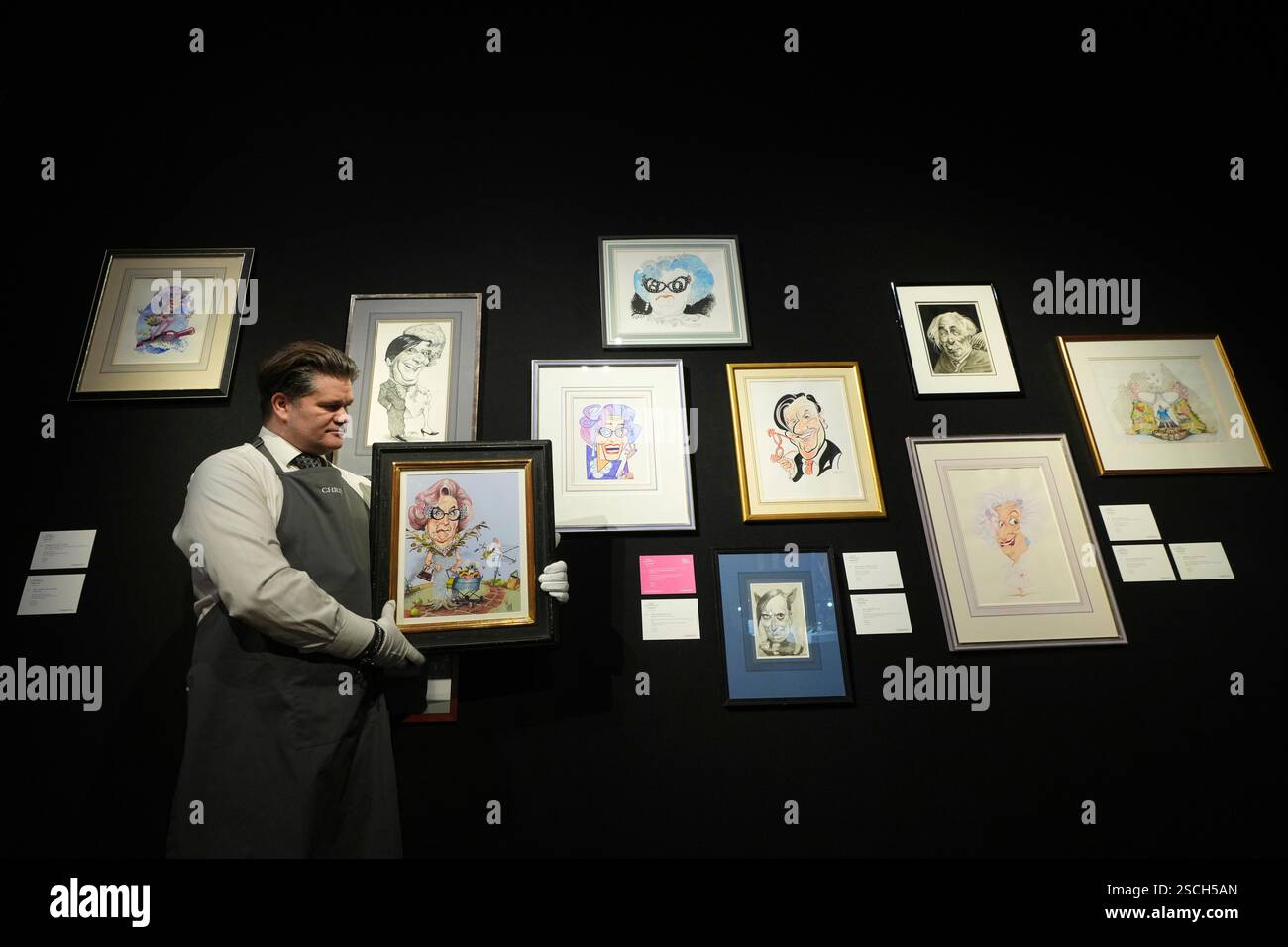 An art handler arranges paintings and drawings ahead of the Barry ...