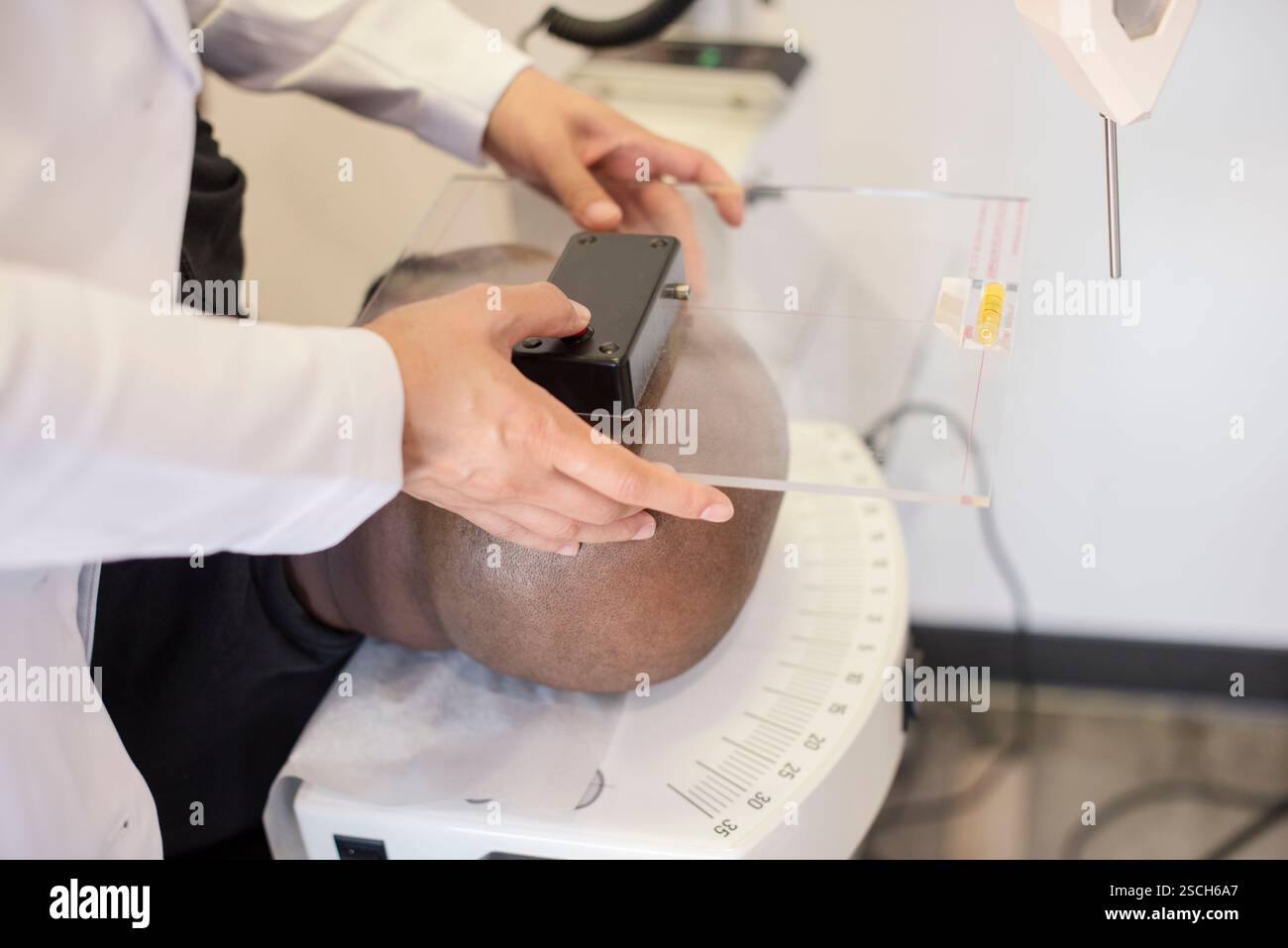 Doctor looking at patients measurements with equipment Stock Photo - Alamy