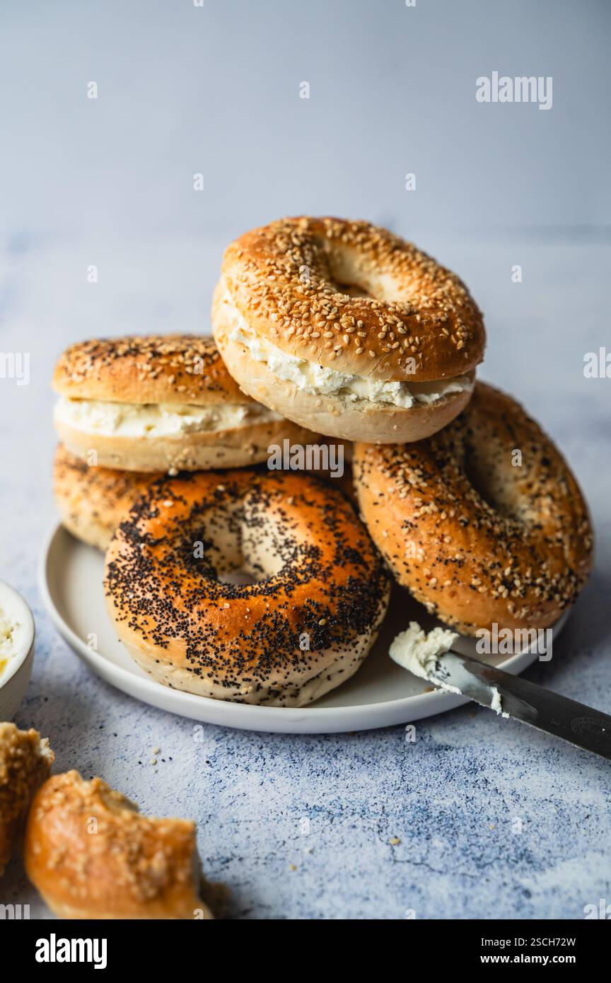 Close up of a pile of assorted bagels with cream cheese Stock Photo - Alamy