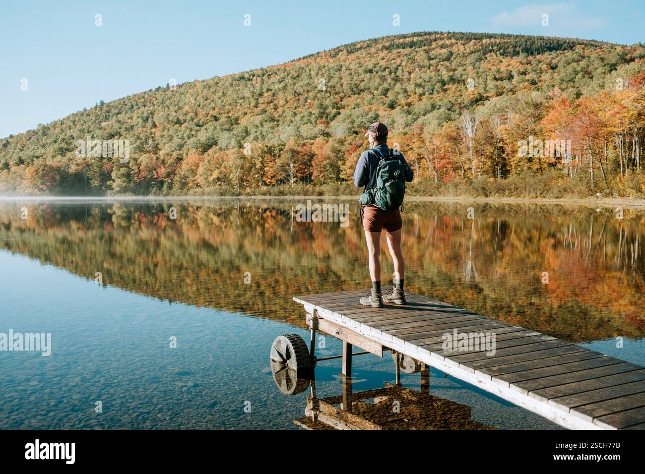 Woman walking on dock lake hi-res stock photography and images - Alamy