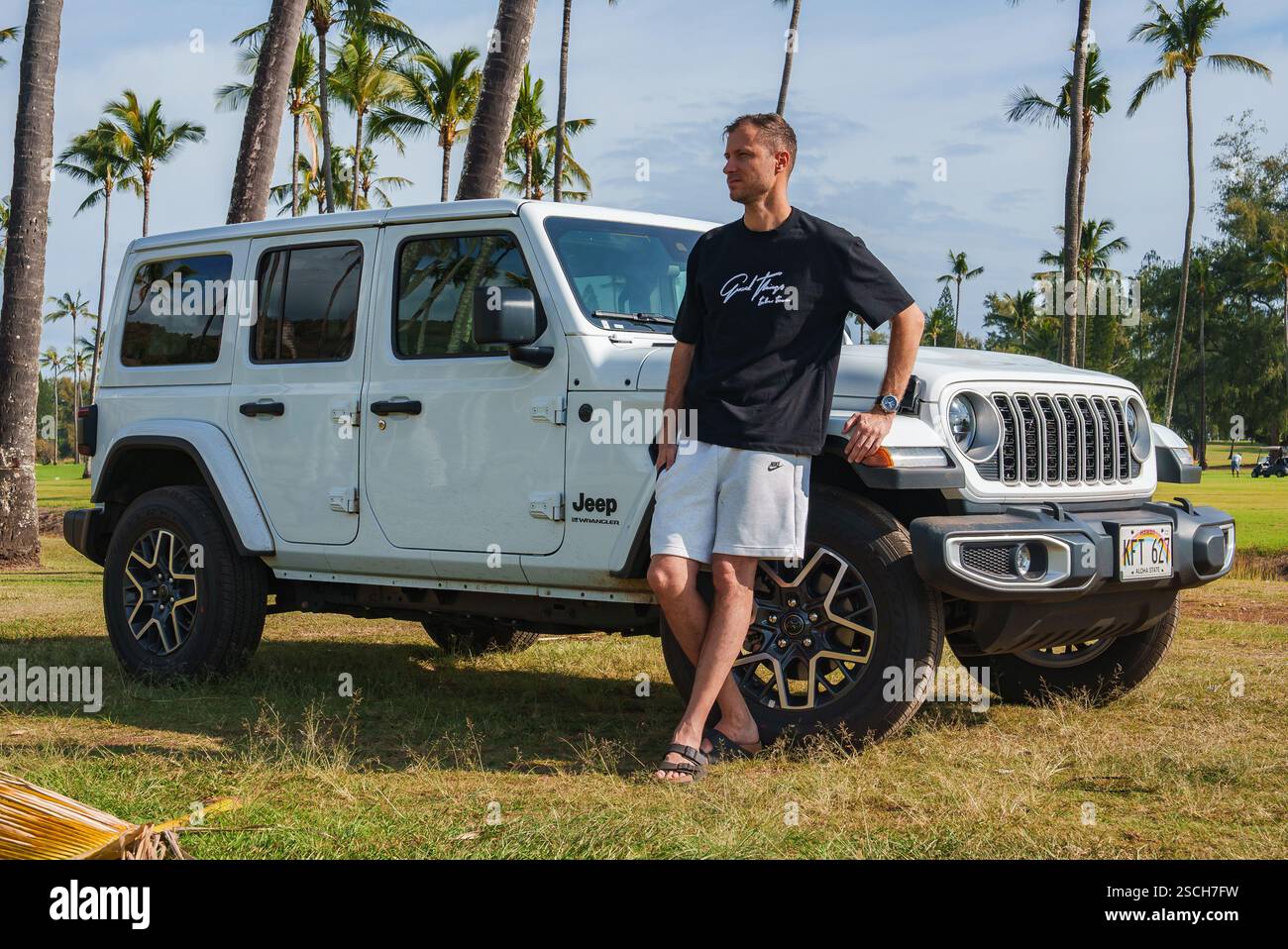Man Leaning on White Jeep Wrangler Among Palm Trees in Hawaii Stock ...