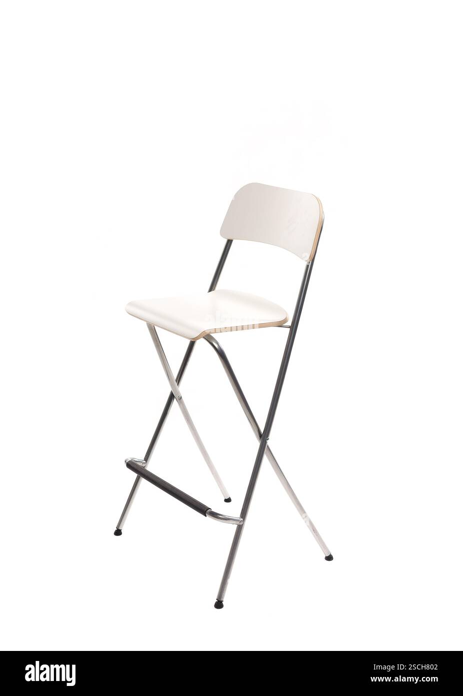 Simple white folding chair stands against a plain backdrop for ...