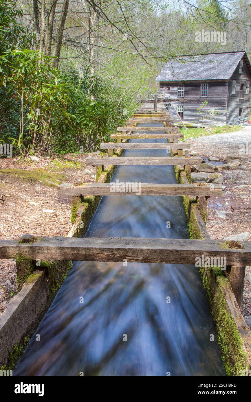 Water flows through a wooden flume, powering a historic mill Stock ...
