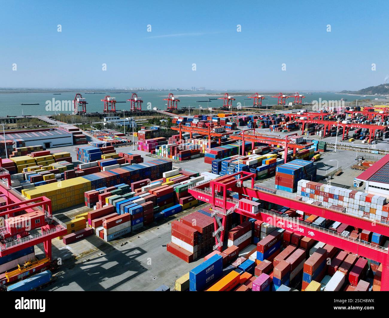 WUHU, CHINA - FEBRUARY 7, 2025 - Cargo ships load and unload containers ...
