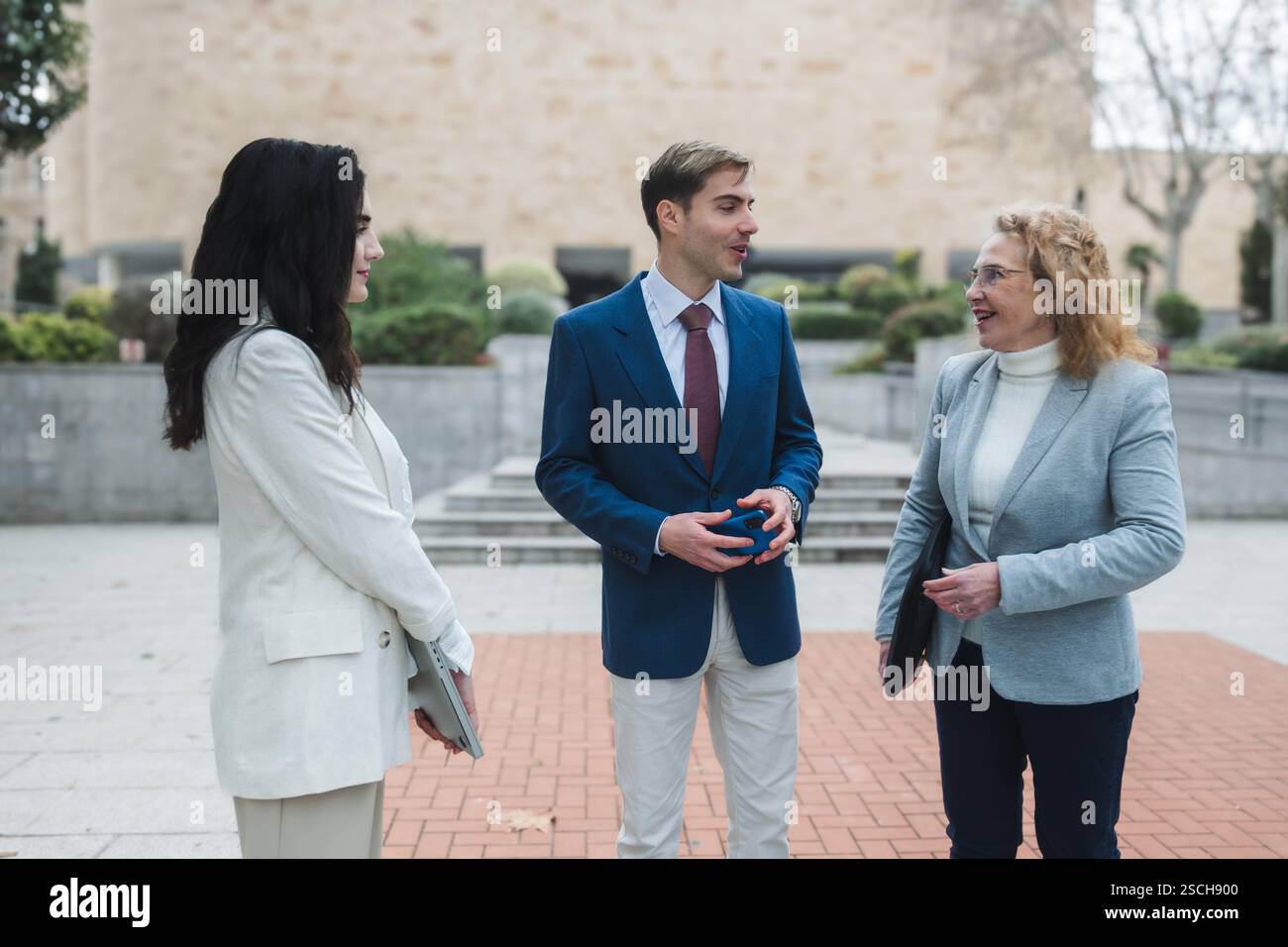 Businesspeople talking outside office building during break time Stock ...