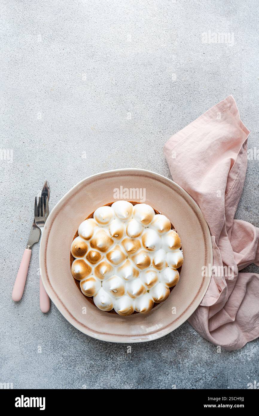 A beautifully presented homemade lemon cake on a pastel pink plate with ...