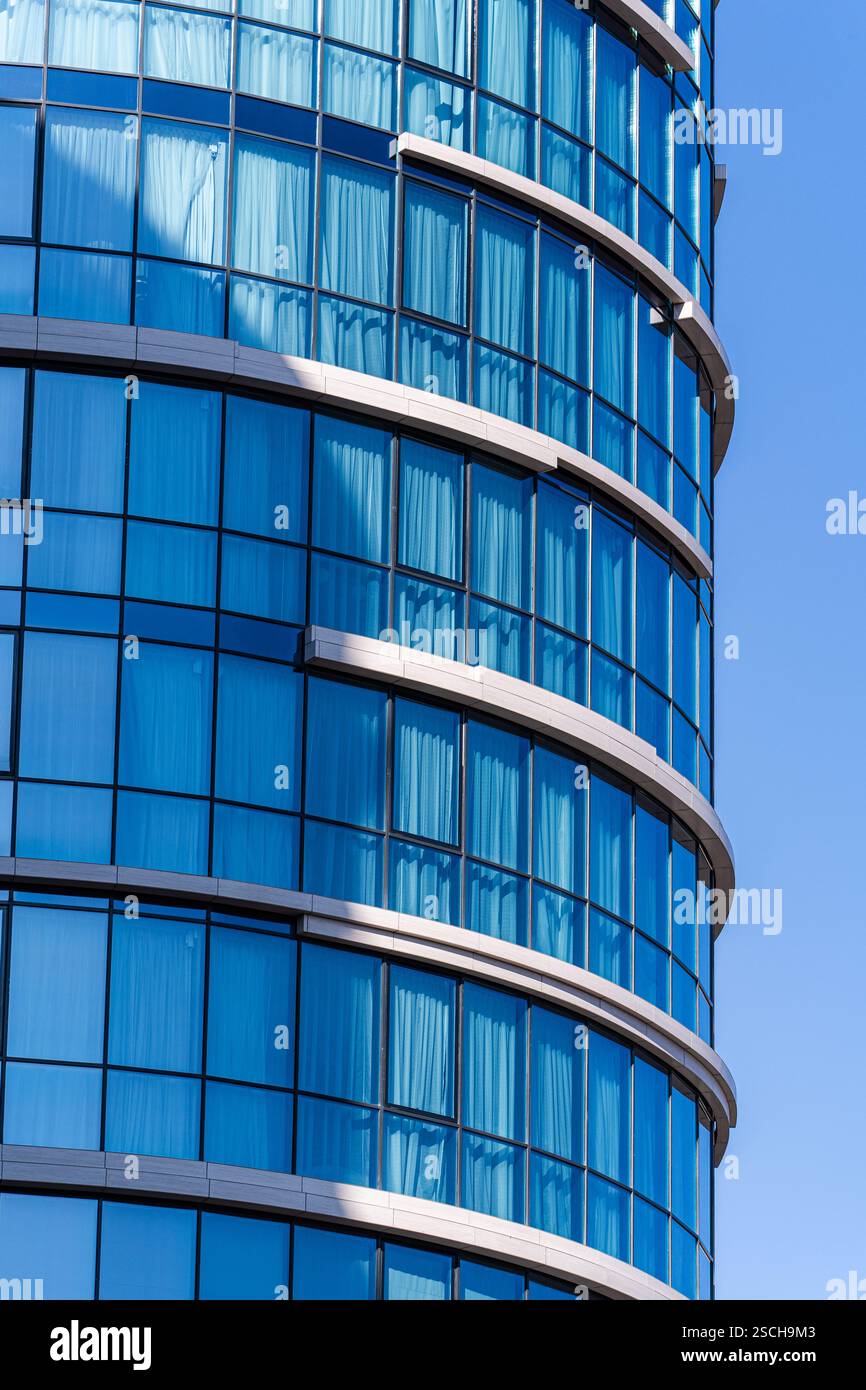 Modern architecture, highlighting a curved building with a vibrant blue ...