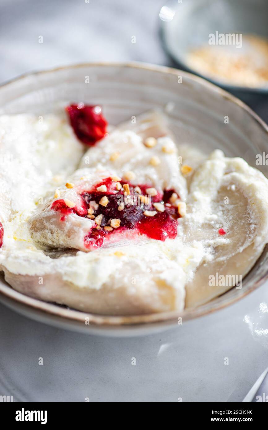 Traditional Ukrainian varenyky filled with cherry, elegantly served ...