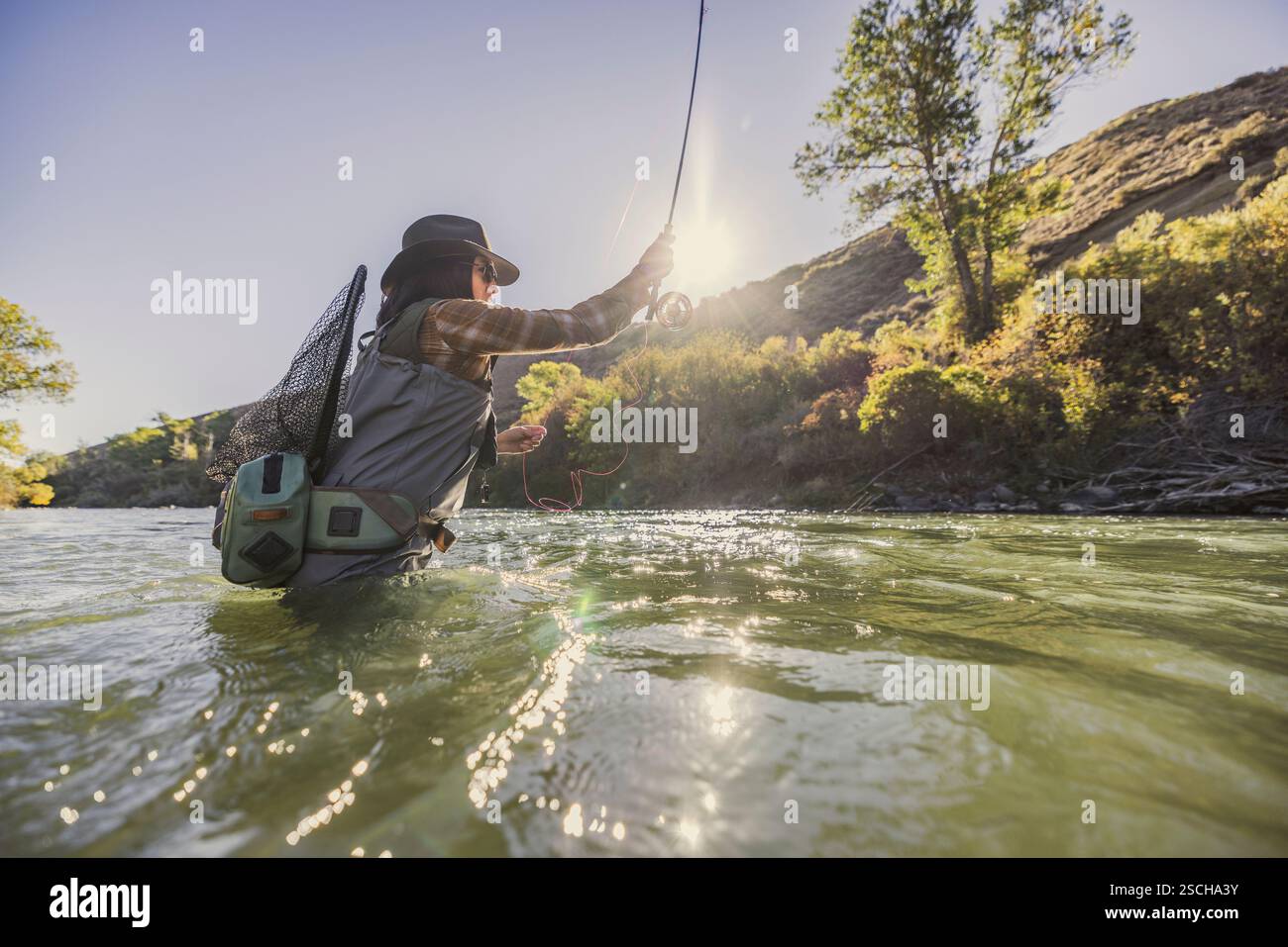 Fly fishing woman cast to trout in a river Stock Photo - Alamy