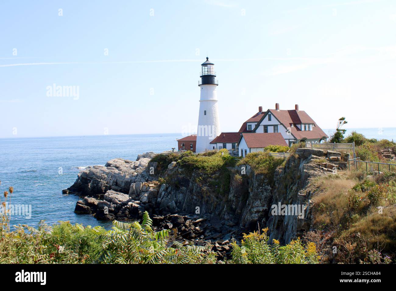 Rugged coast surrounding a lighthouse Stock Photo - Alamy