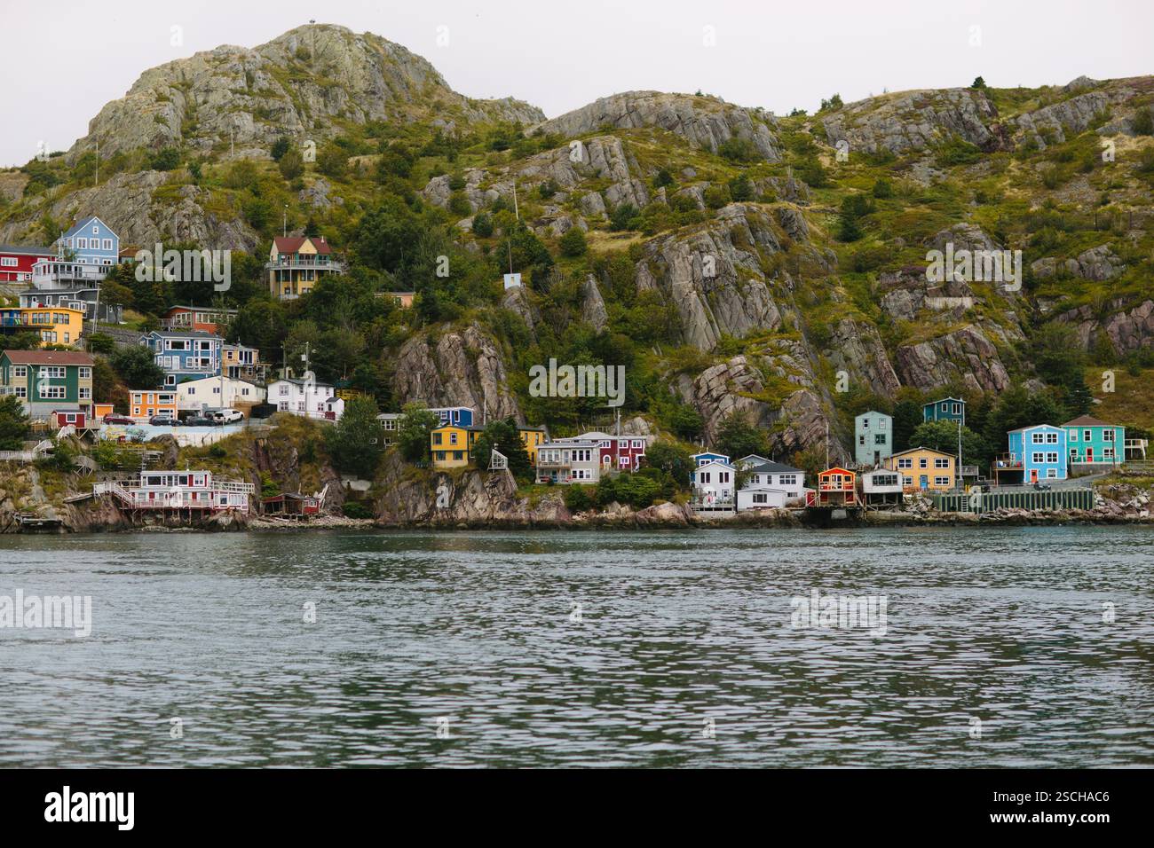 Vibrant, colorful houses cling to the rugged cliffs of St. John's ...