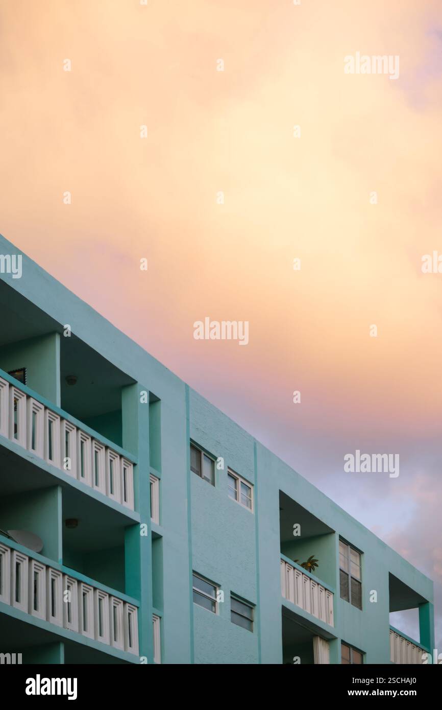 Soft sunset colors bathe a Miami Beach building, rendering the sky in ...