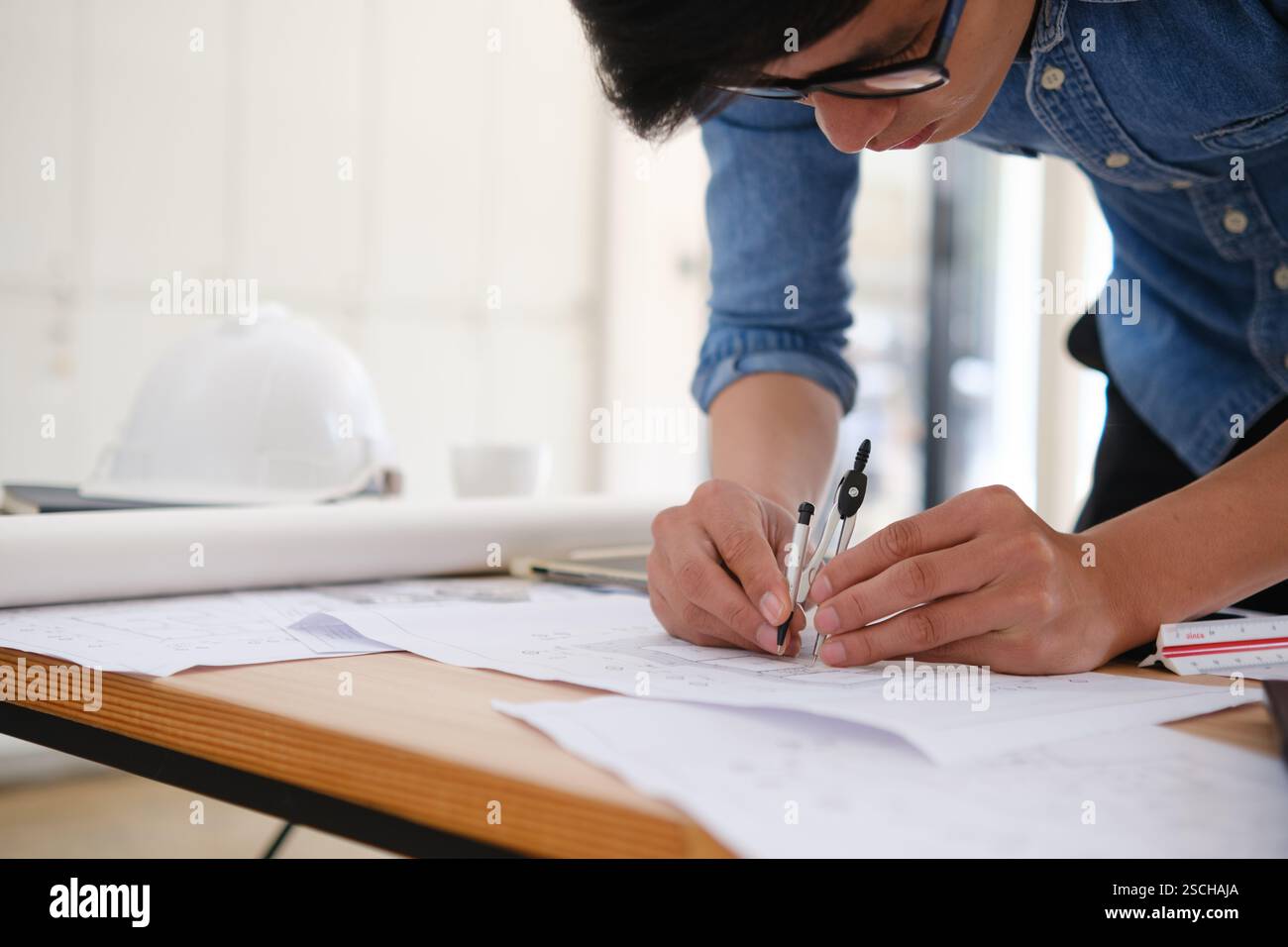 Architect designing house plans using a compass Stock Photo - Alamy
