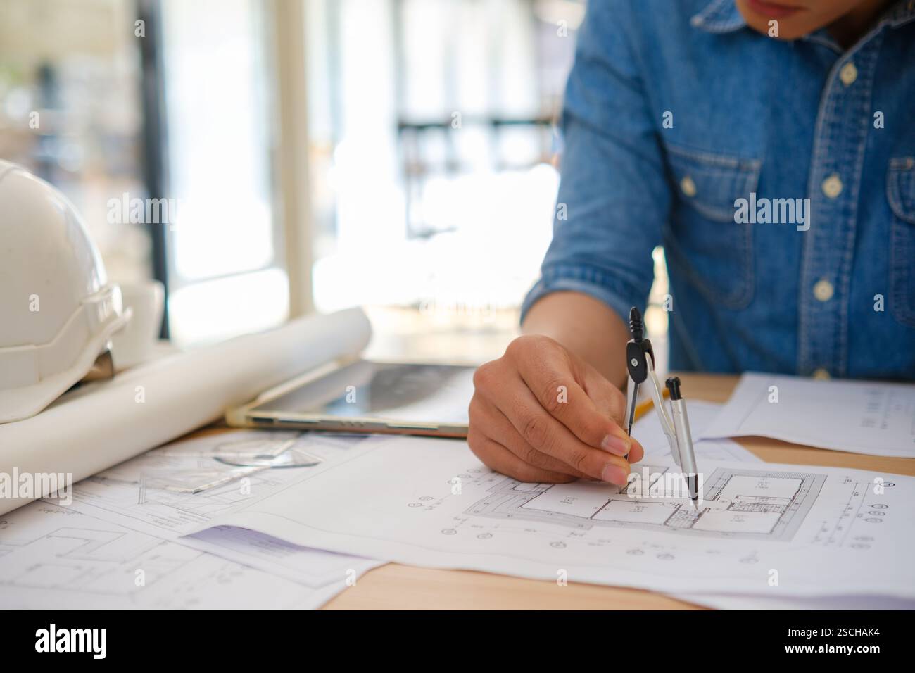 Architect designing house plans using a compass on a work desk Stock ...
