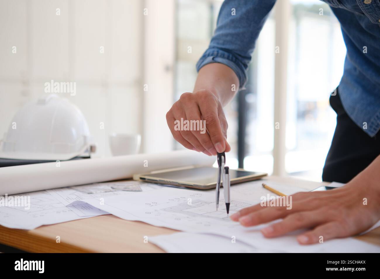 Architect designing house plans using a compass Stock Photo - Alamy
