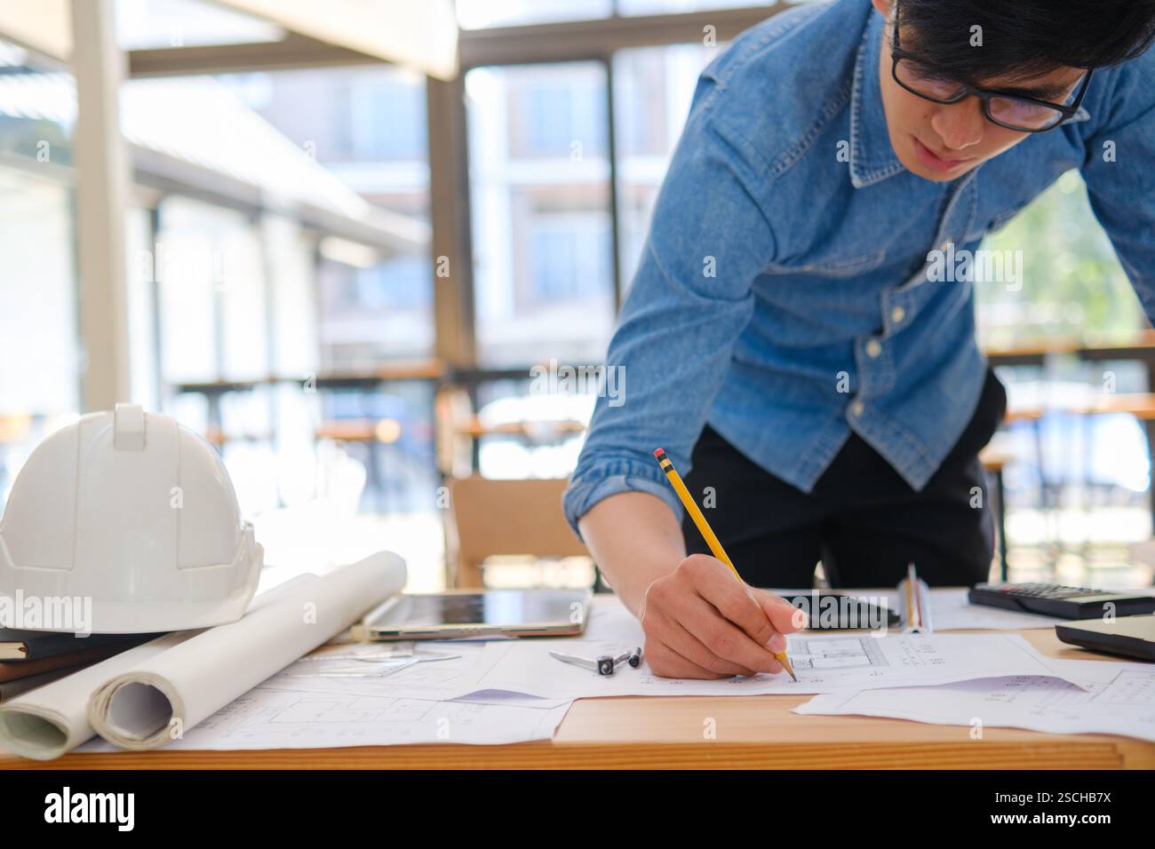 Young architect sketching house plans Stock Photo - Alamy