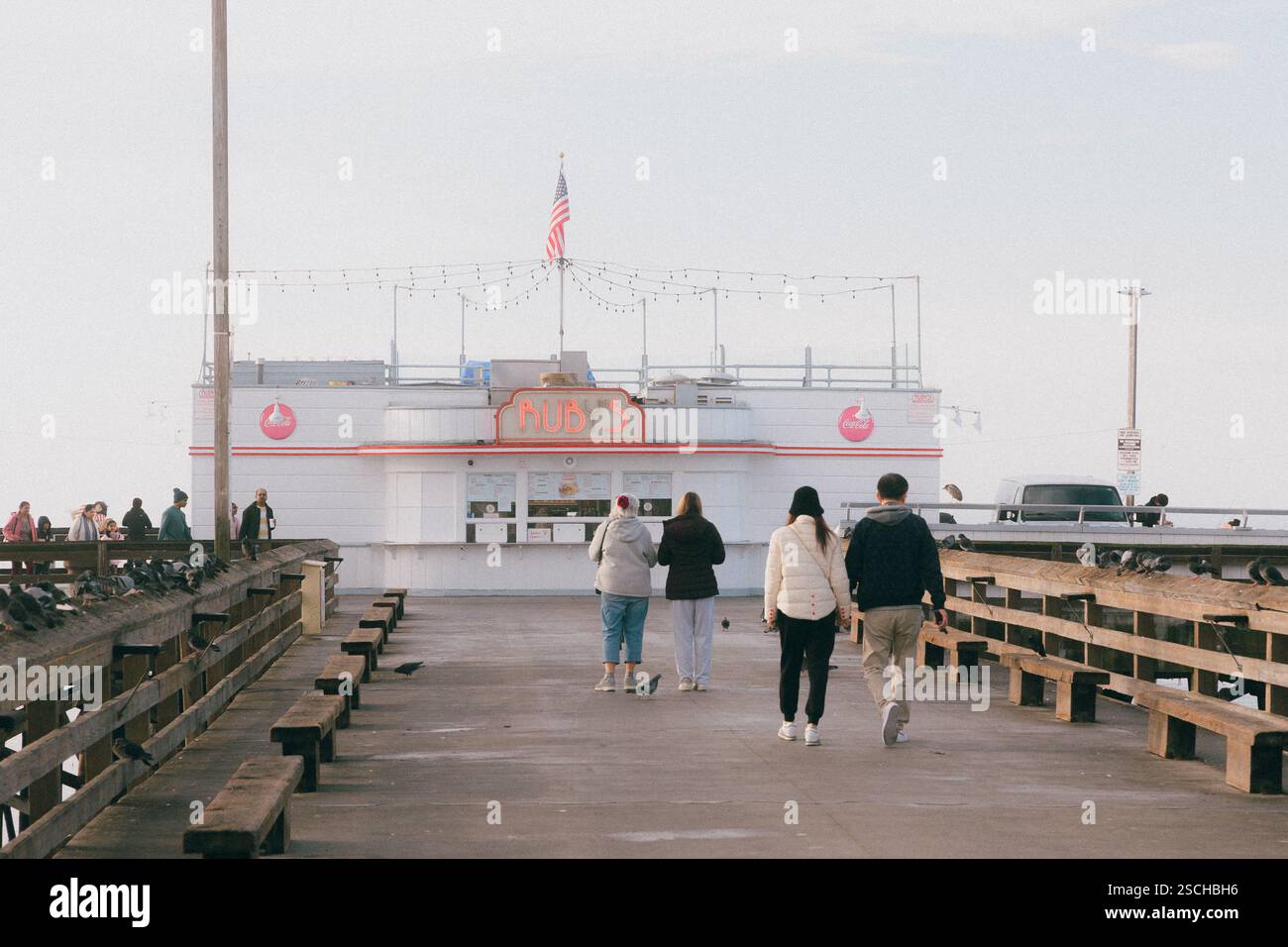 Tourist walking towards Ruby's Diner on Newport Pier during morning ...
