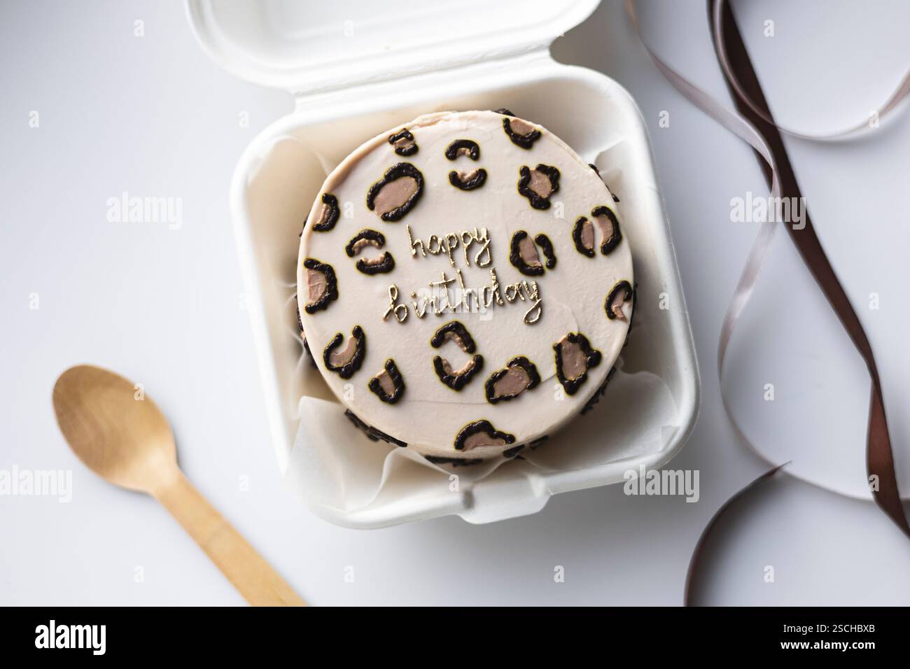 Top view of a mini bento birthday cake styled with a leopard print ...
