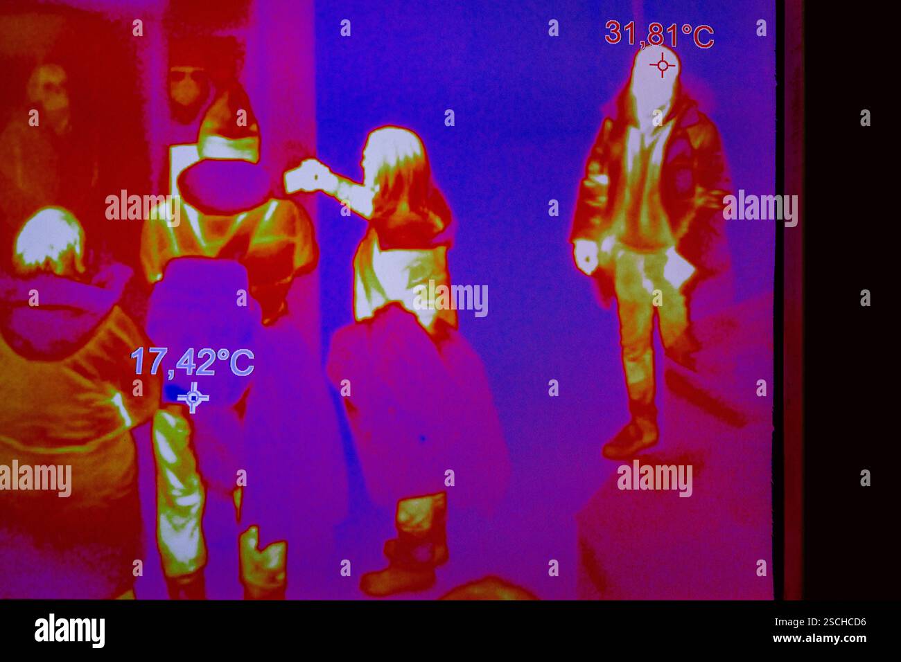 A thermal imaging display showing a group of people indoors in ...