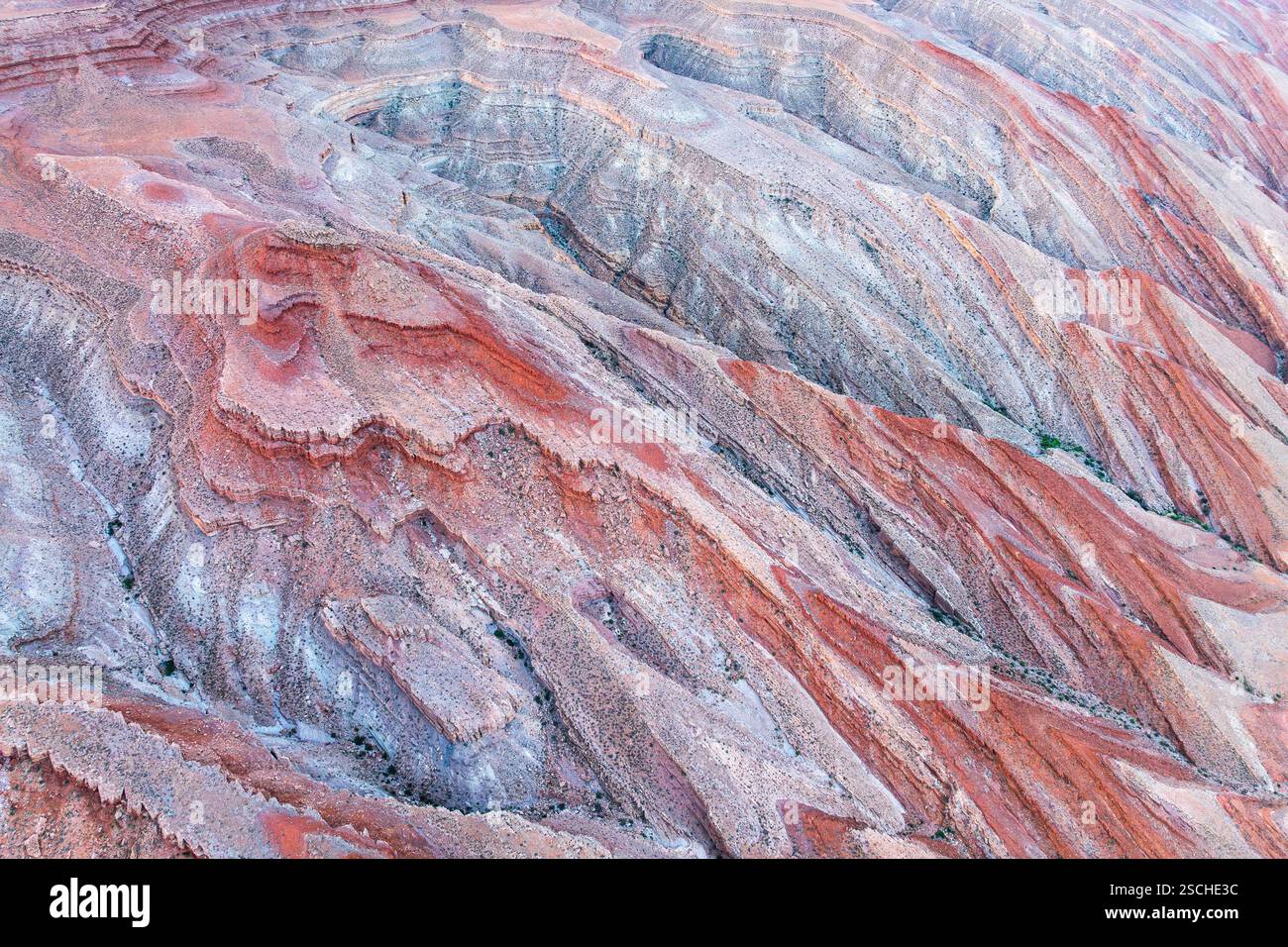 Striking aerial view featuring the vivid, layered rock formations of a ...