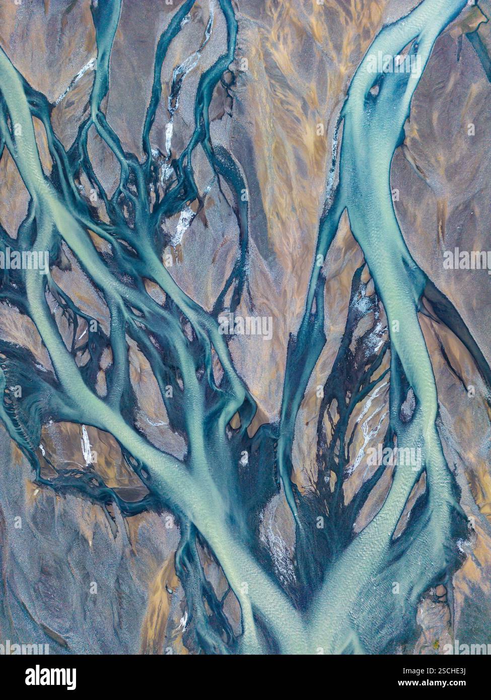 Aerial shot showcasing the intricate patterns and stunning colors of river deltas along the ...