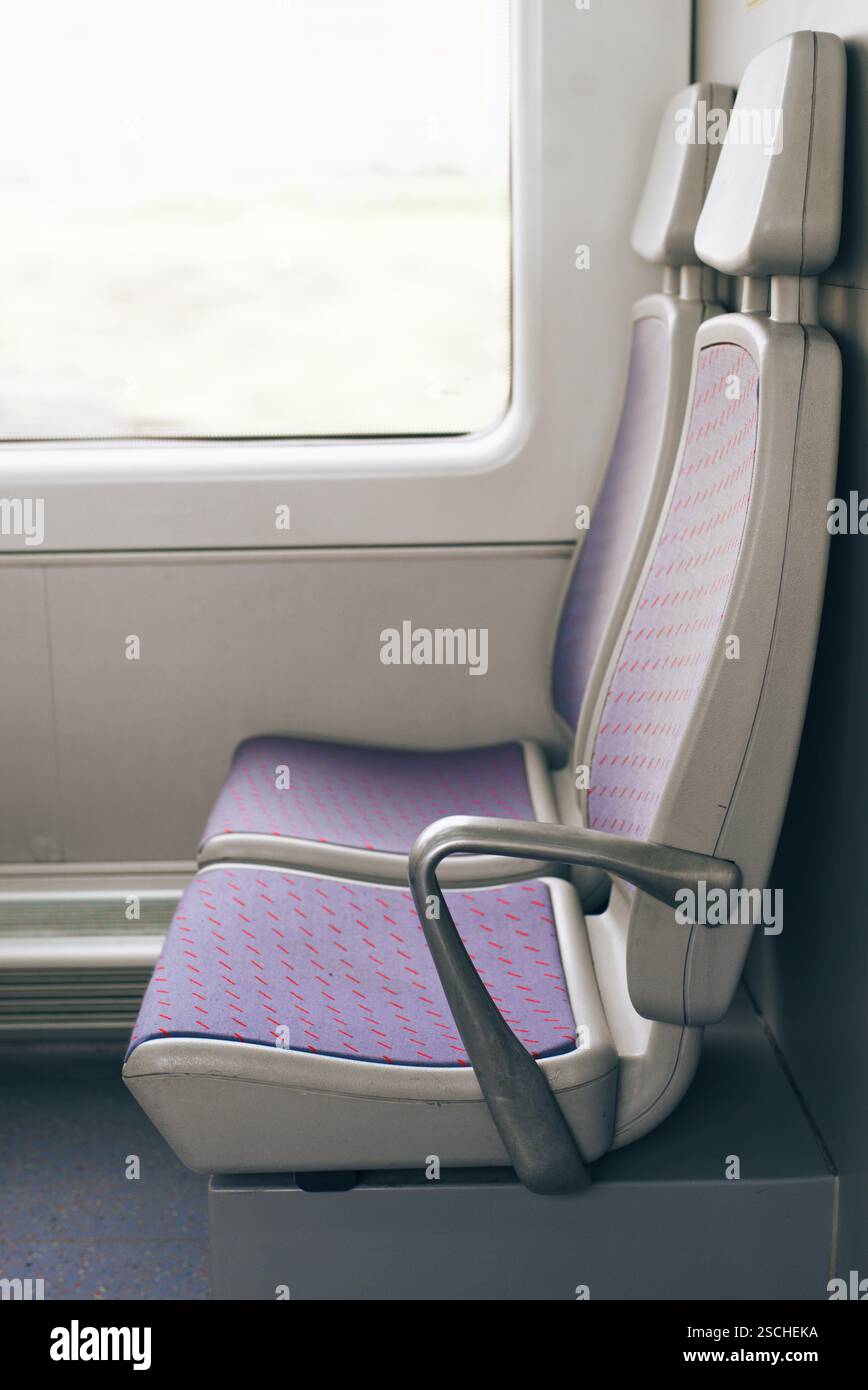 A close up of two empty train seats showing modern design, upholstered ...