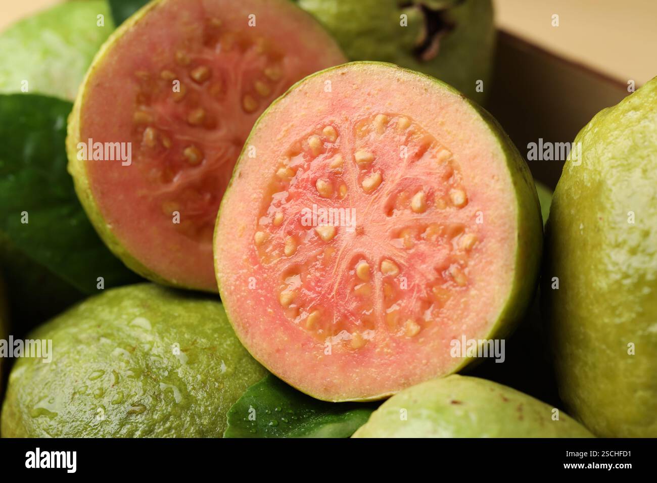 Fresh cut and whole guava fruits, closeup Stock Photo - Alamy