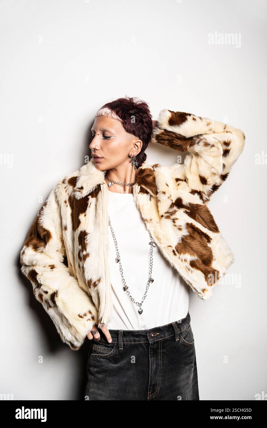 A woman with distinctive makeup and jewelry poses confidently in a ...