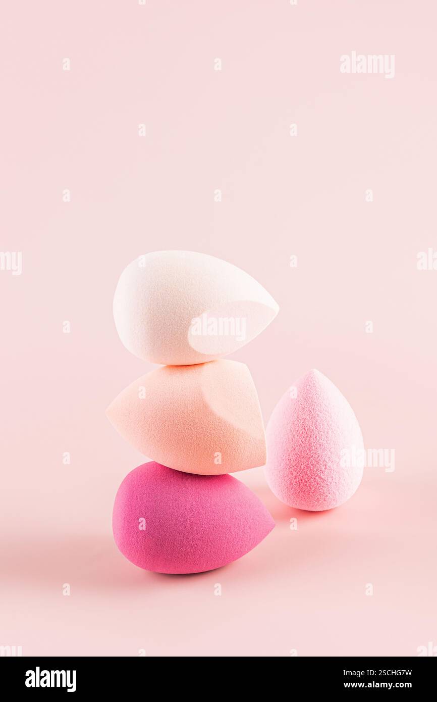 Delicately balanced stack of vibrant makeup sponges, showcasing various ...