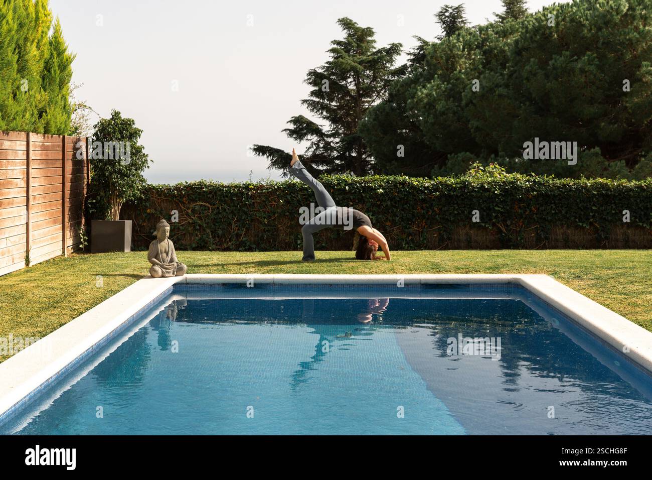 A woman practices the one-legged wheel pose (Eka Pada Urdhva ...