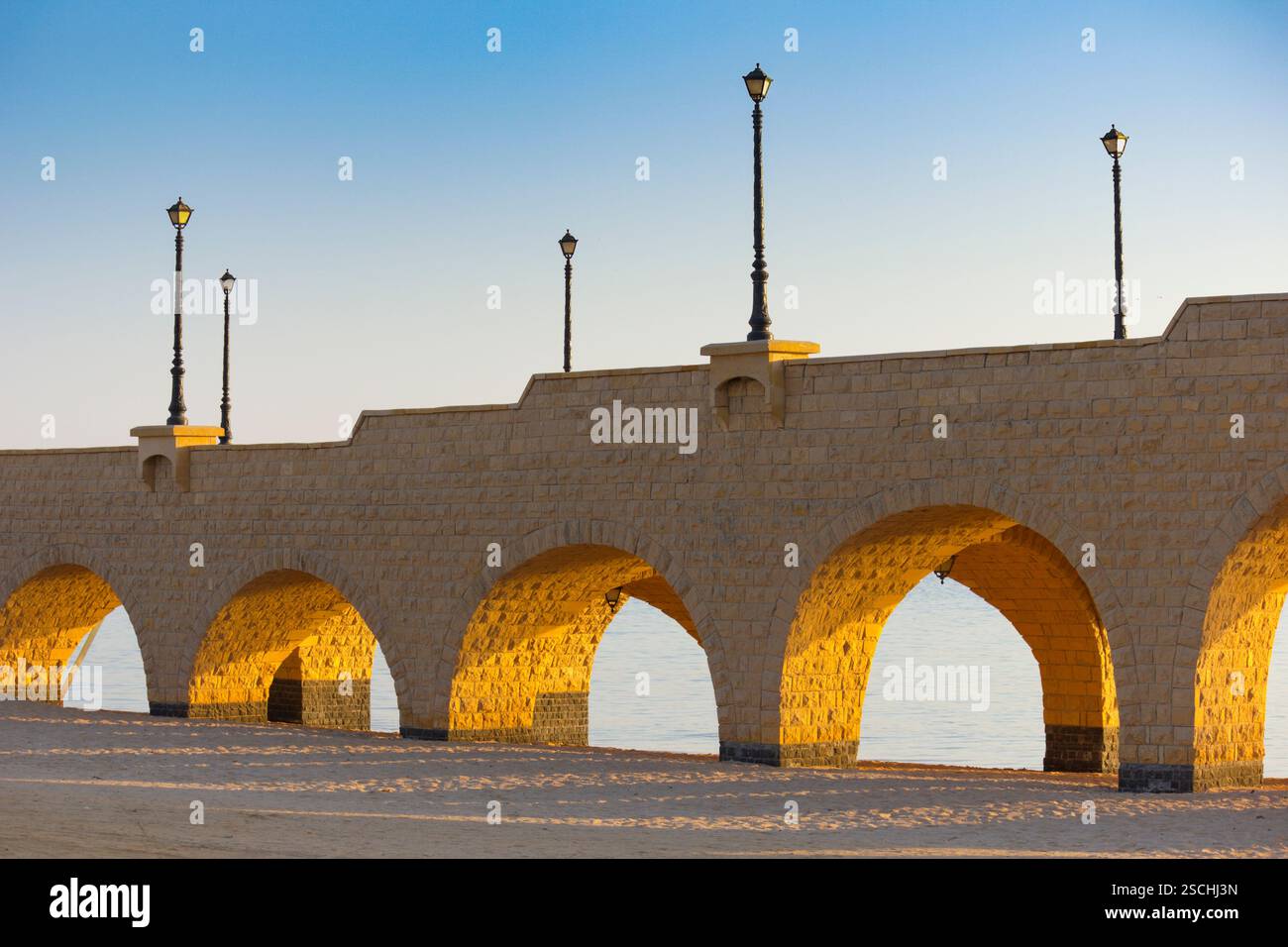The arched stone colonnade with suspended lanterns Stock Photo - Alamy