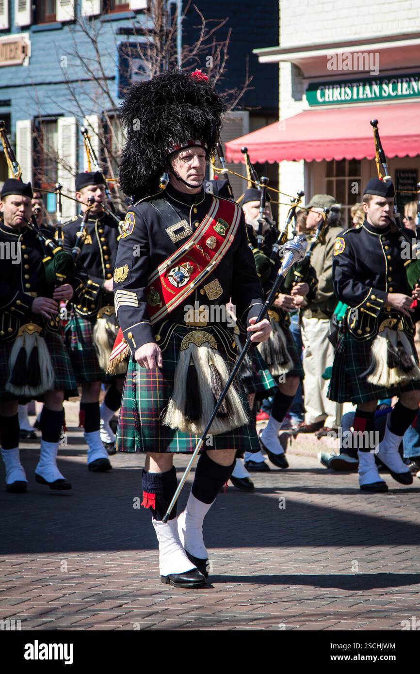 Piping band members in kilts march, playing bagpipes. Parade Stock ...