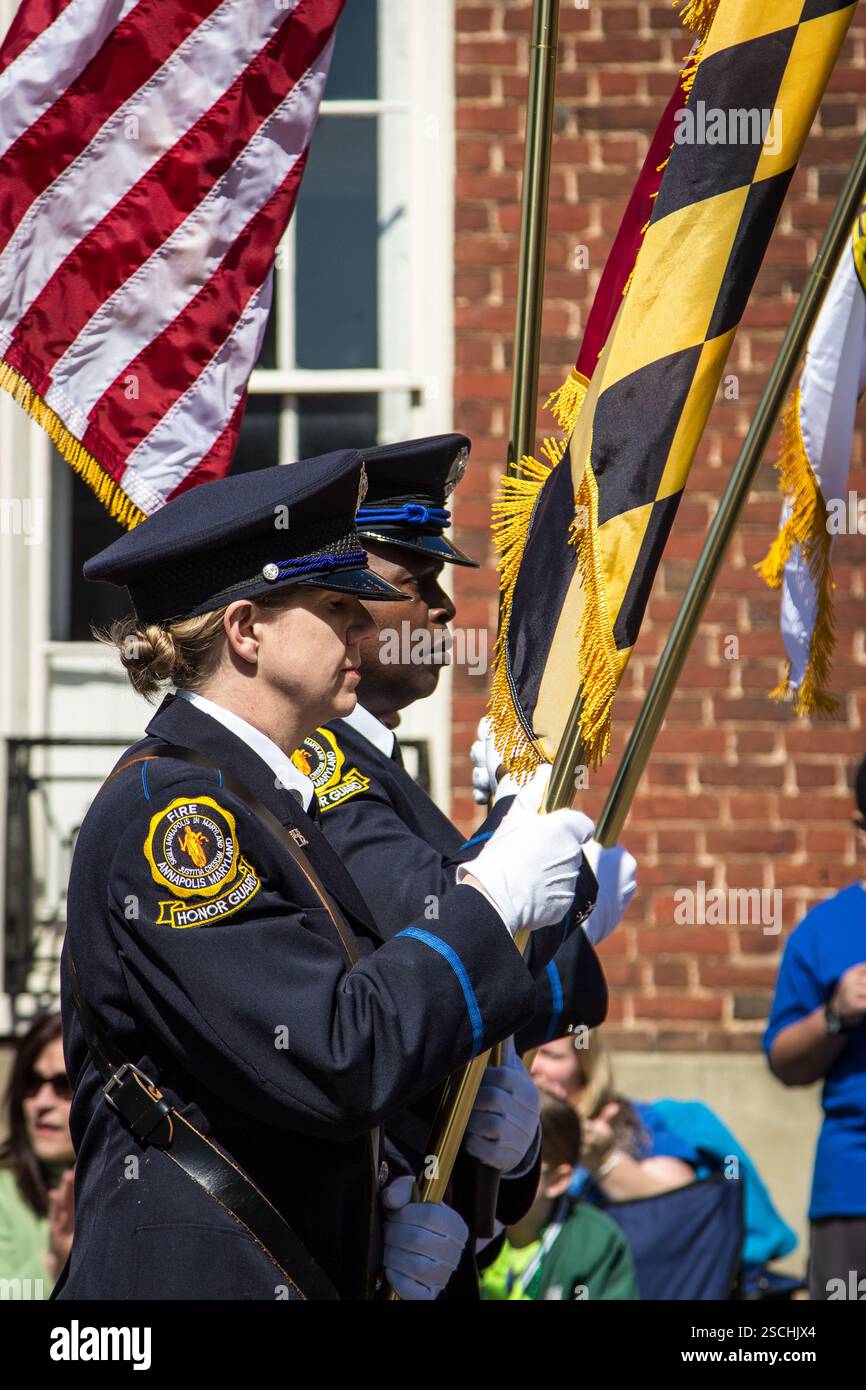 Firefighters carry flags, including the US and Maryland flags, in a ...