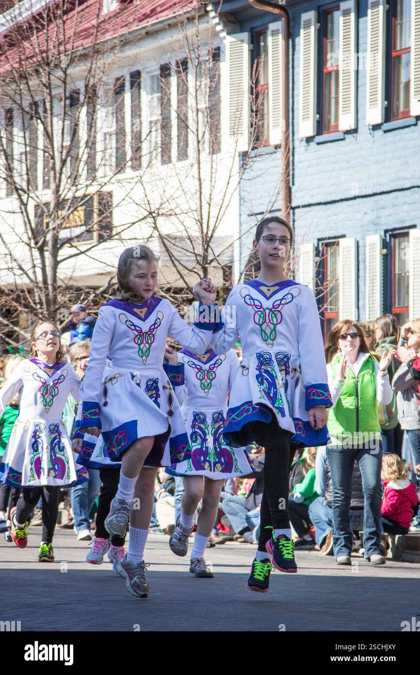 Irish dancers (girls) in traditional costumes, performing at a parade ...