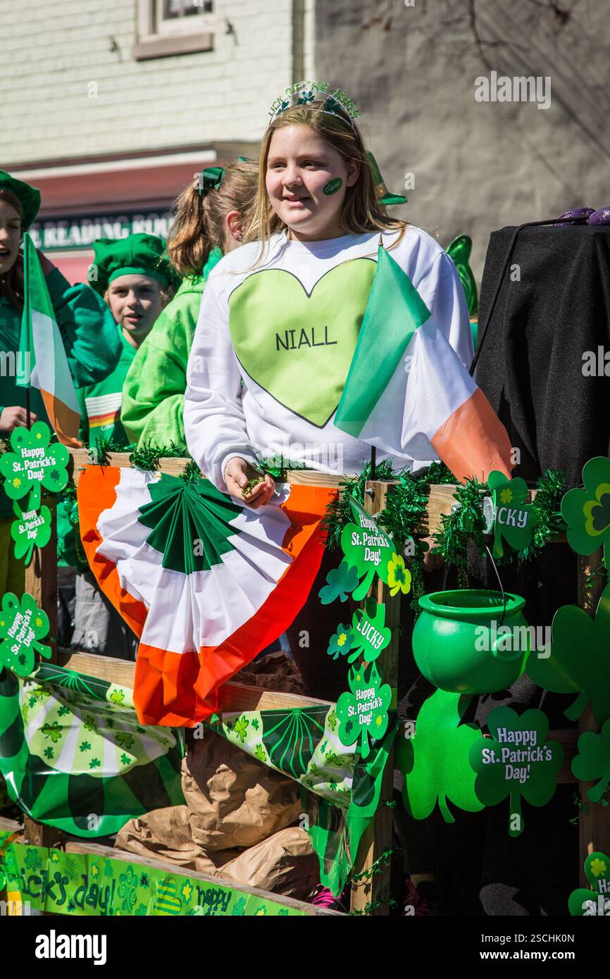 St. Patrick's Day parade float. Kids in green, flags, and a "NIALL ...