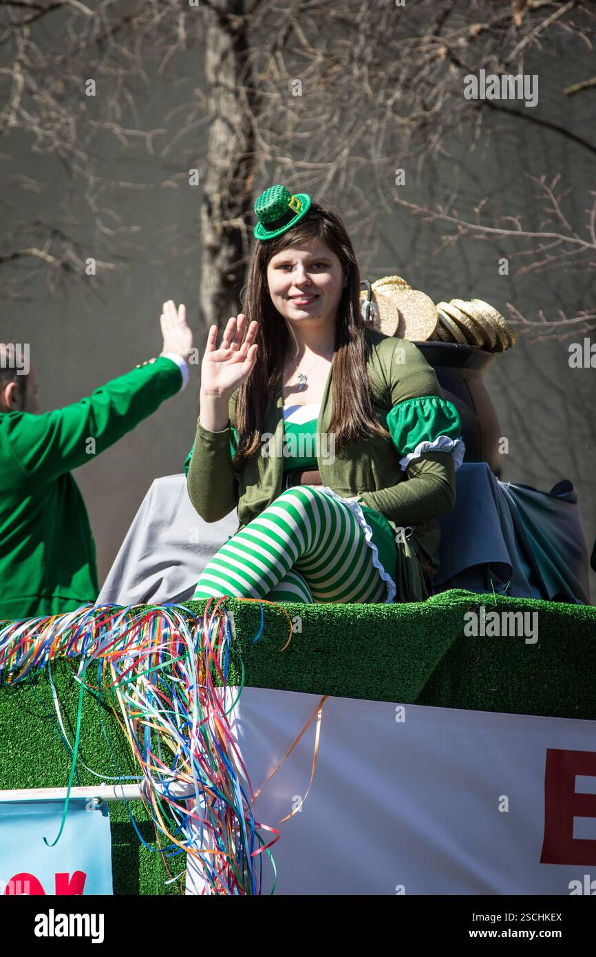 St. Patrick's Day parade. Woman in leprechaun costume waves. Part of a ...