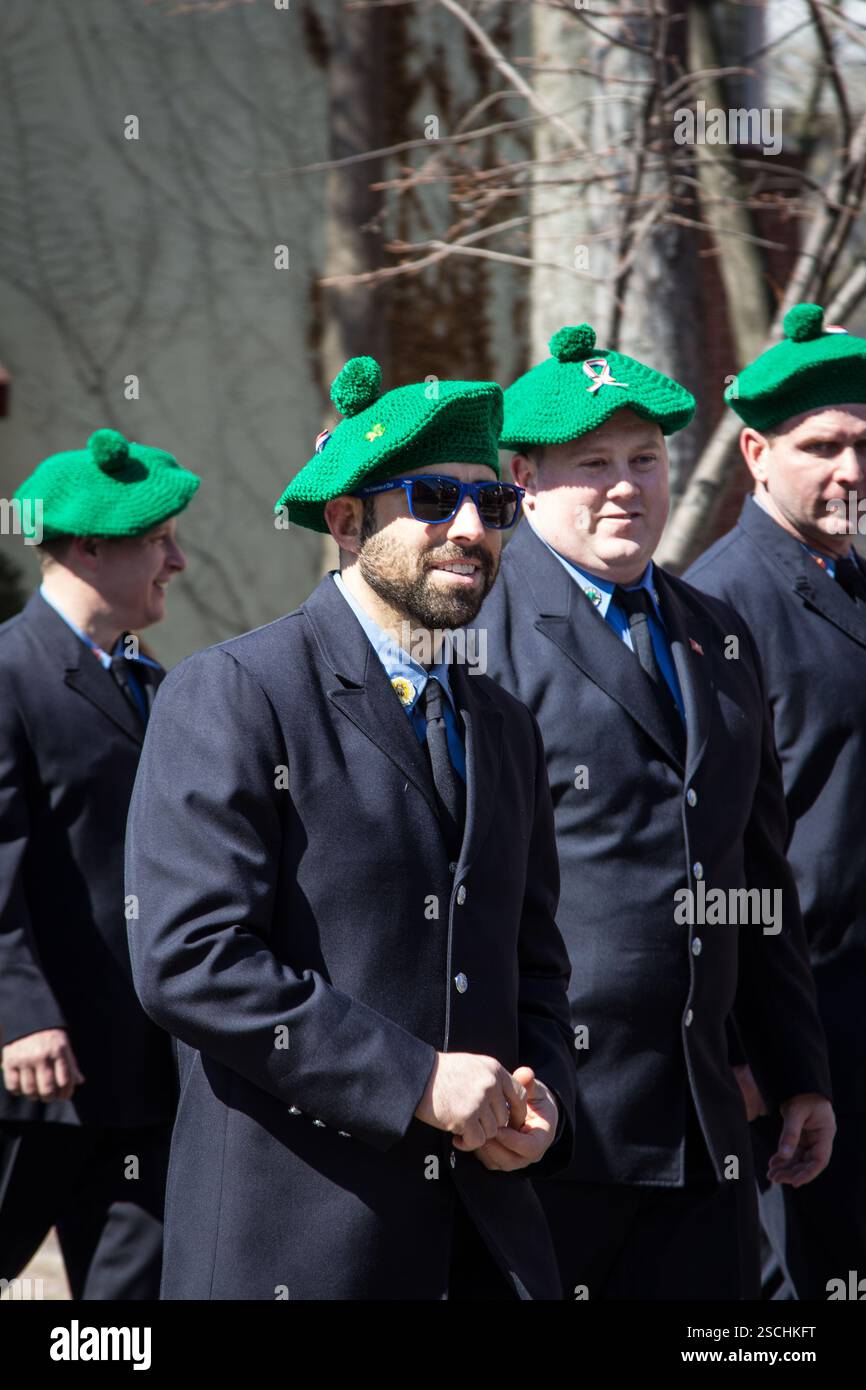 Men in green berets, dark suits, likely in a St. Patrick's Day parade ...