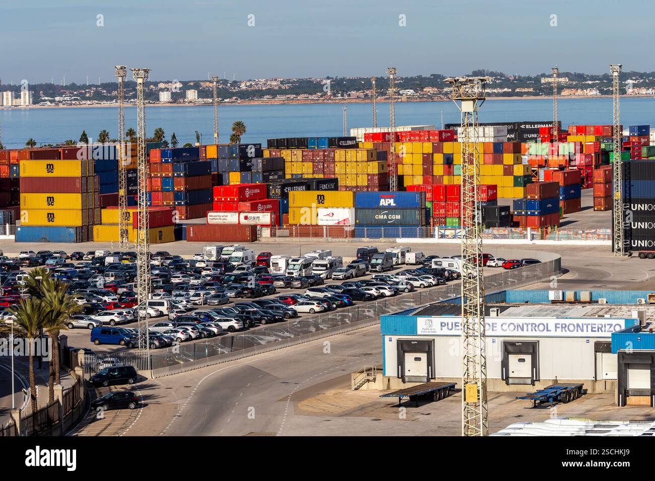Becauseecode Border Control in Dock area with parked cars and stacks of ...