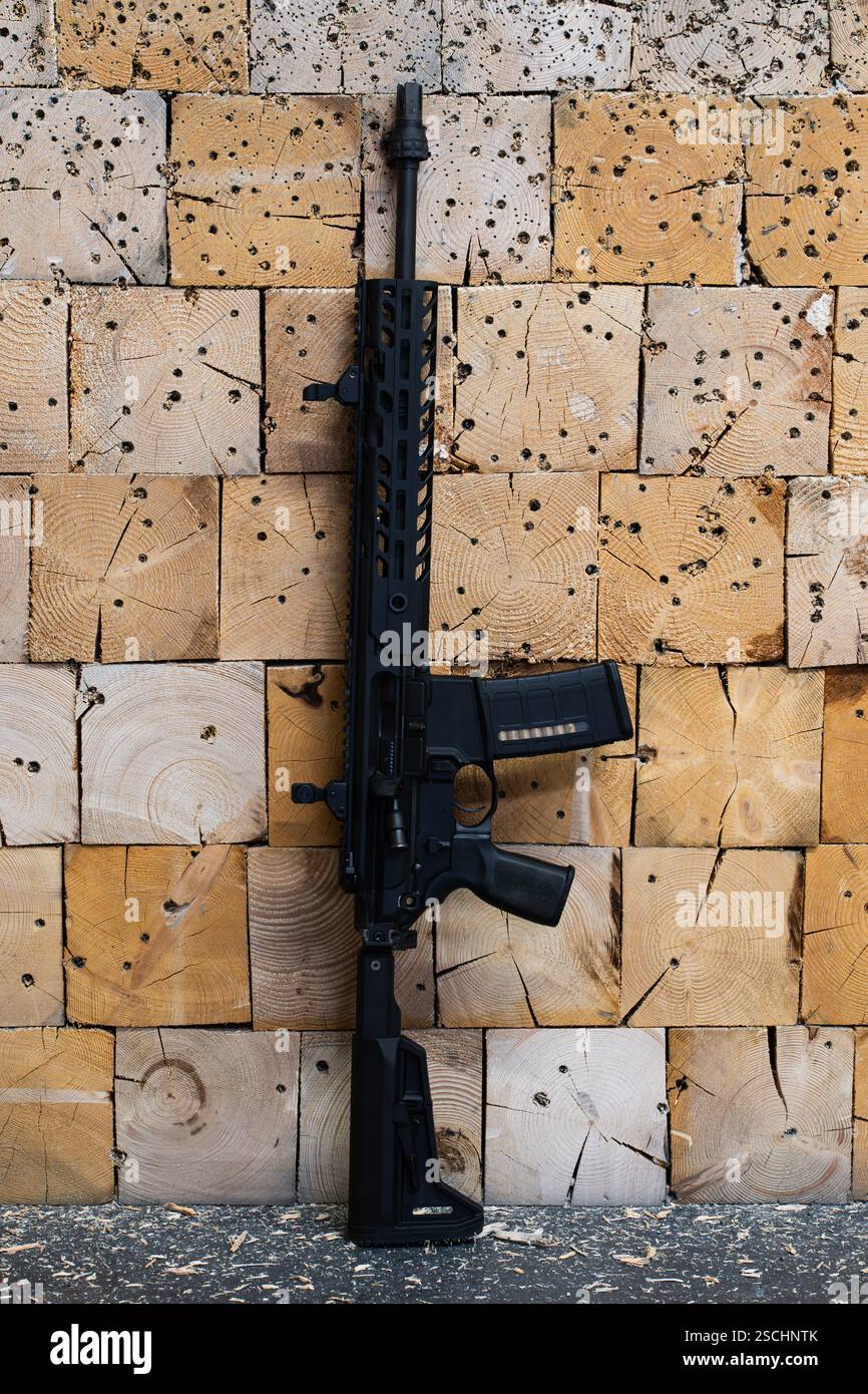 Modern American rifle near a bullet trap in a shooting range, close-up ...