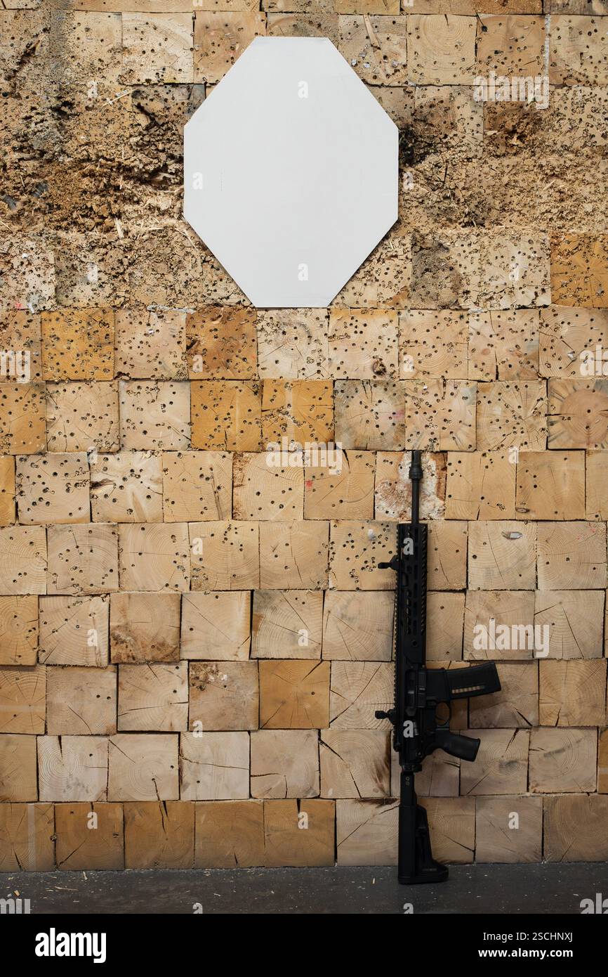 Shooting in a shooting range with weapons, target on a bullet trap and ...