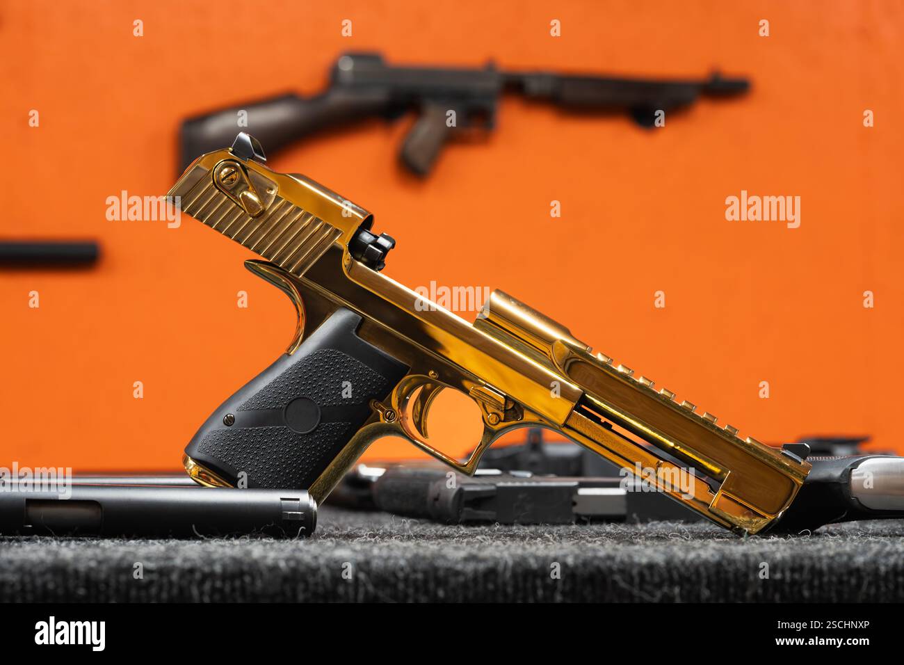 A beautiful large gold-colored pistol at a shooting range Stock Photo ...