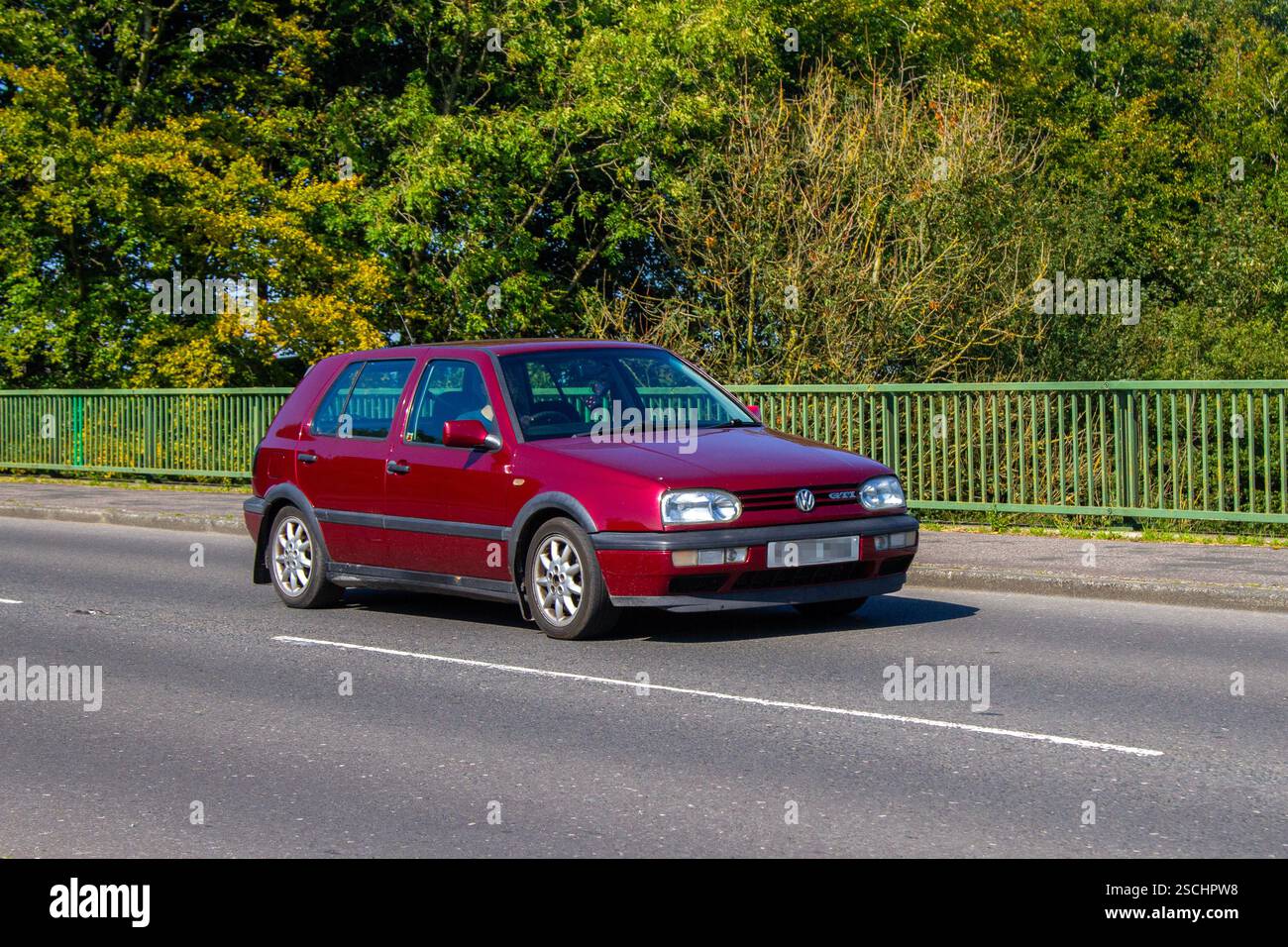 1997 90s nineties Red VW Golf GTi crossing motorway bridge in ...